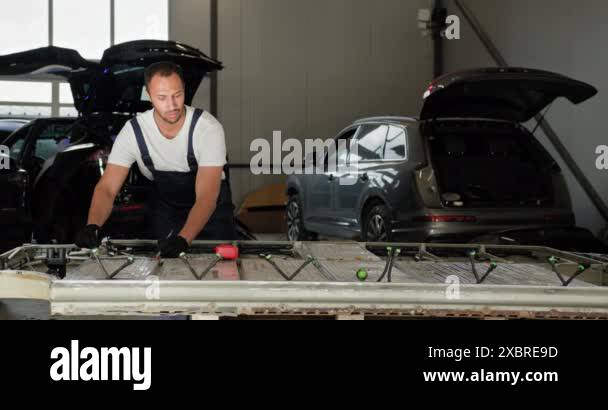 Male Technician Inspecting And Repairing An Electric Vehicle Battery In ...