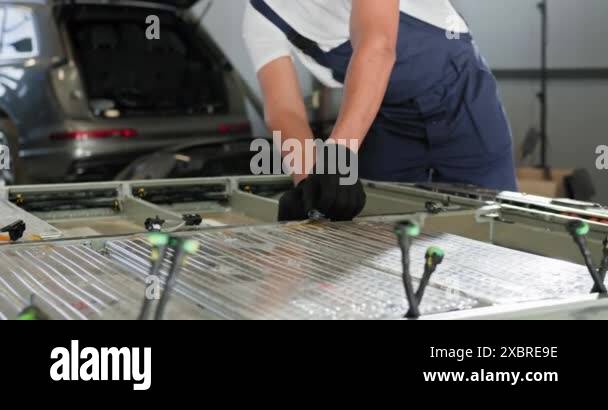 Male Technician Working On Electric Vehicle Battery Module. Modern Used ...