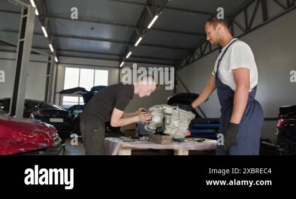 EV service, Electric Car Engine. Two mechanics repairing an electric ...