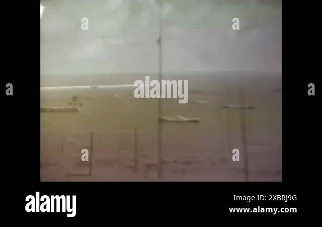 United States Navy warships and a helicopter and an amphibious vehicle ...