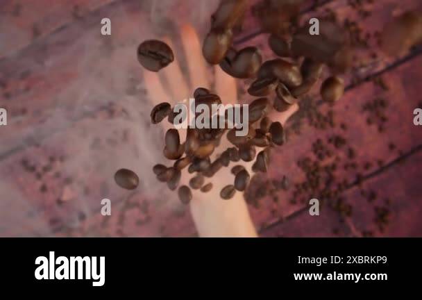 Pile of coffee beans thrown up with hand in slow motion. Shot from ...