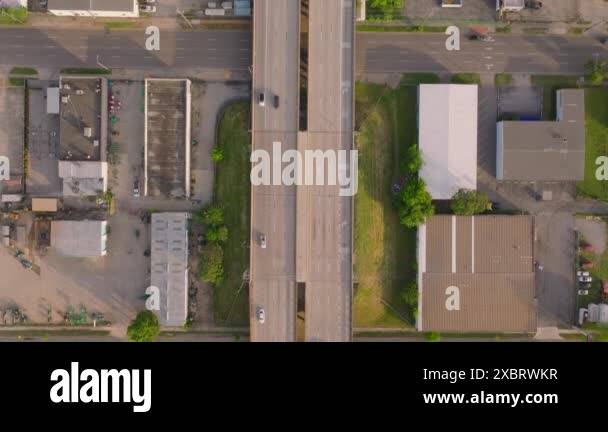 Birds eye view of a highway intersection with cars traffic, industrial ...