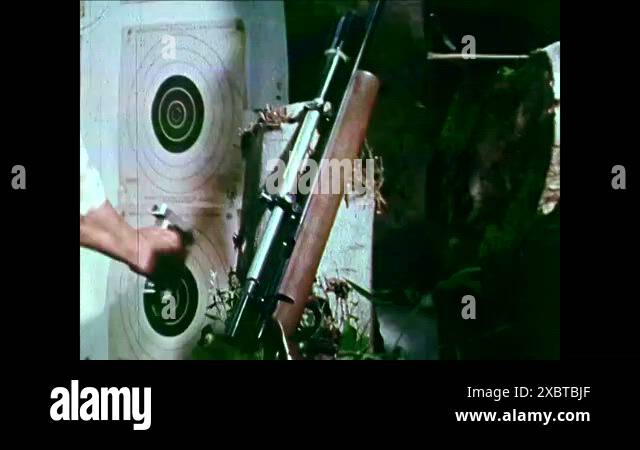 Riflemen shoot center fire rifles at targets on a range in the 1960s ...