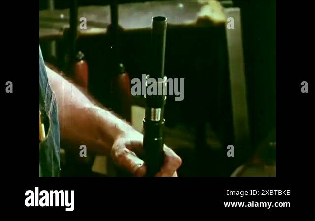 Triggers are magnified for inspection and gunsmiths assemble rifles at ...
