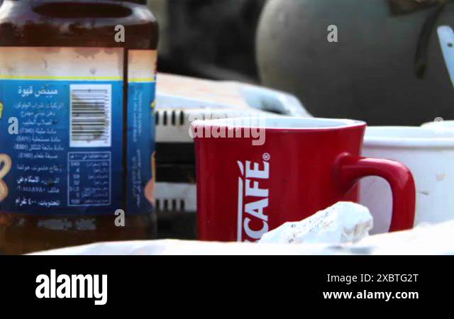 A table of rations stands next to an Israel army unit and their tank ...