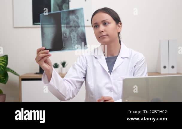 Radiological Assessment: A female doctor in the hospital meticulously ...