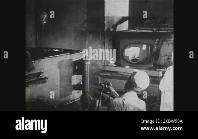 A rubber factory works to crank out tires and bullets during world war ...