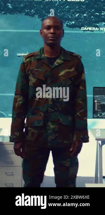 Vertical Video Standing at attention, the soldier executes the military ...