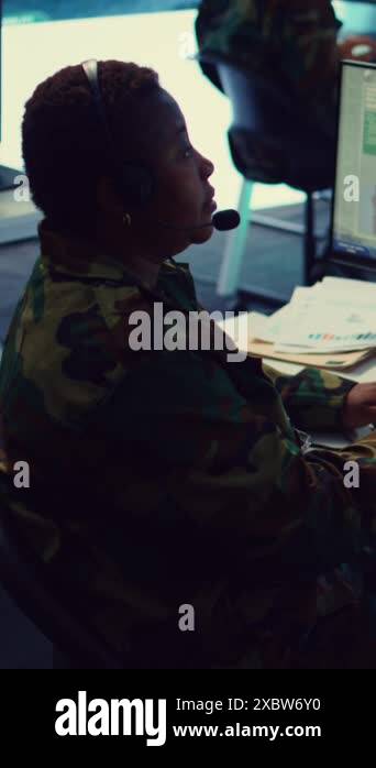 Vertical Video Woman army officer operates on gps surveillance footage ...