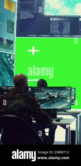 Vertical Video Diverse group of privates operating on a big screen ...