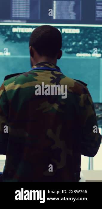 Vertical Video Army officer examines satellite radar footage to gather intelligence for a new ...