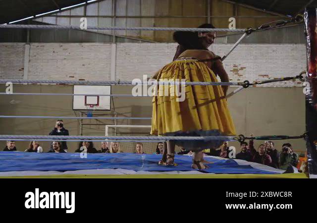 Female woman cholita wrestlers in native costume fight in a boxing ring ...