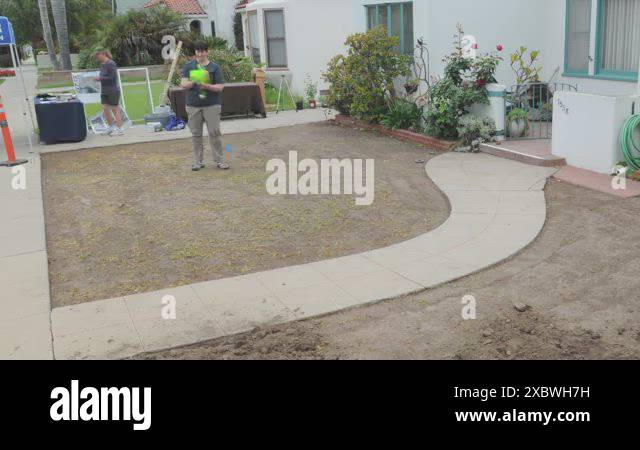 A large community builds a garden in the front yard of a home Stock ...
