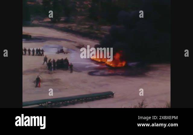 1969 - US Navy firefighters in training work with low velocity fog ...