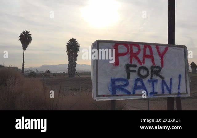 A sign says Pray For Rain along a California highway during a time of ...