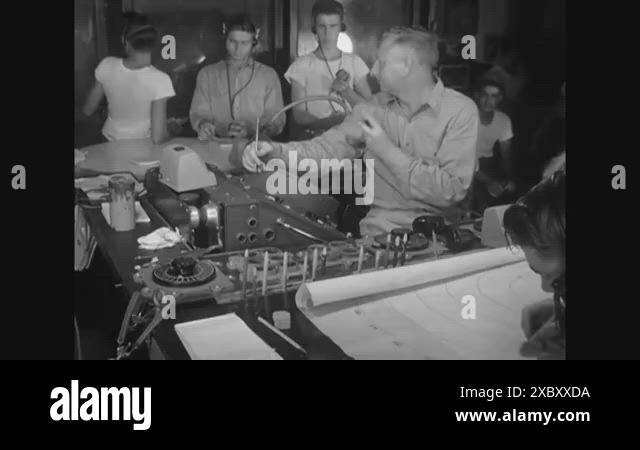1946 - Plotting devices, phones and other equipment are used in the CIC ...