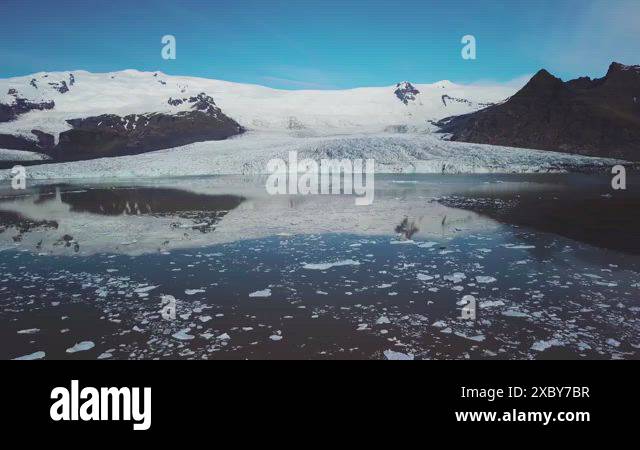 Slow aerial approaching the Vatnajokull glacier at Fjallsarlon, Iceland ...