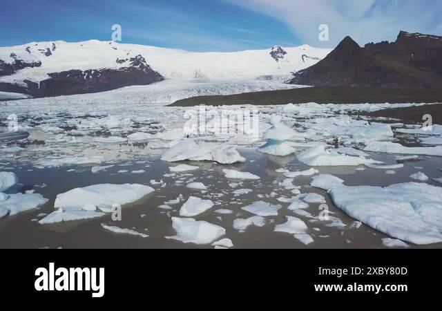 Slow aerial approaching the Vatnajokull glacier at Fjallsarlon, Iceland ...