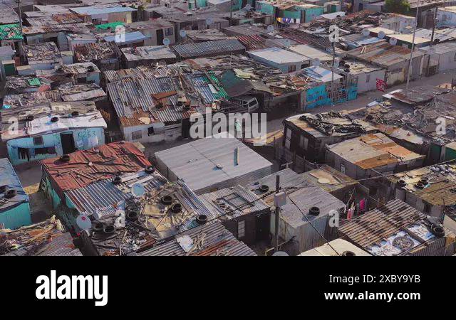 Aerial over ramshackle tin roofs of Gugulethu, one of the poverty ...