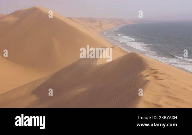High winds blow across the amazing sand dunes of the Namib Desert along ...