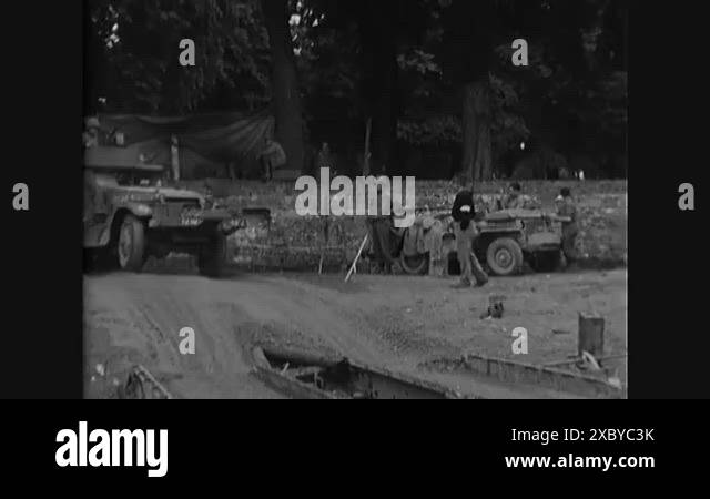 1944 - A US Army armored column drives over a pontoon bridge in ...