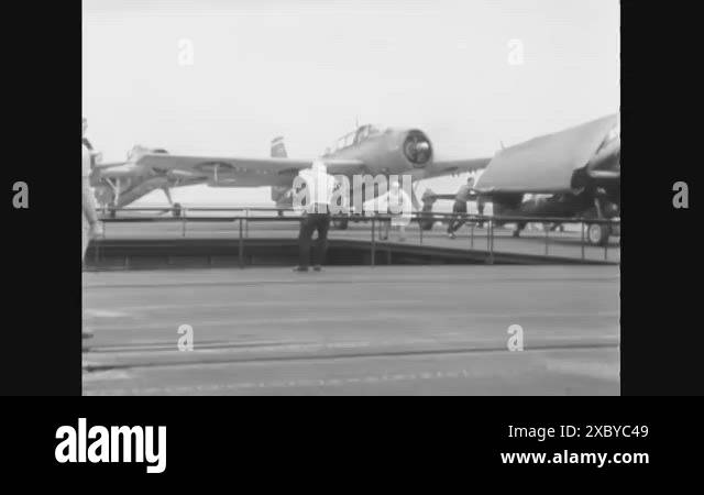 1940s - US Navy torpedo planes are raised onto the flight deck of an ...
