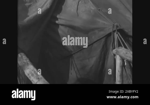 1945 - American soldiers enter and leave a shower tent on their base in ...