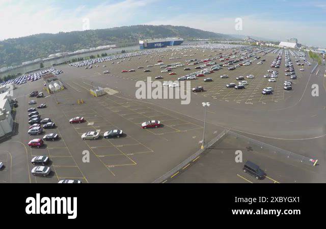 An aerial over vast mostly empty parking lots at a shipping container ...
