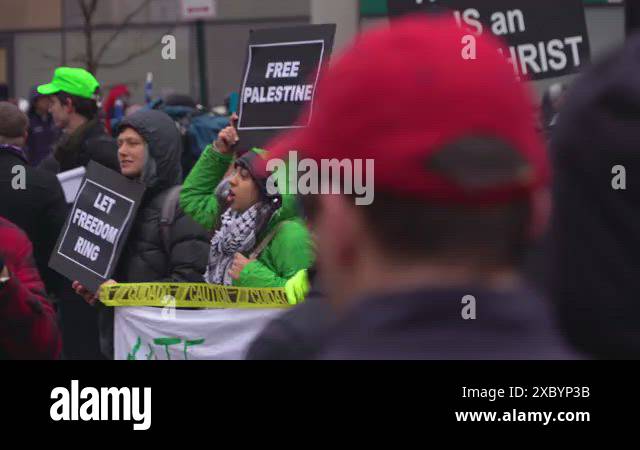 Protestors hold up signs saying free Palestine during an anti-Trump ...