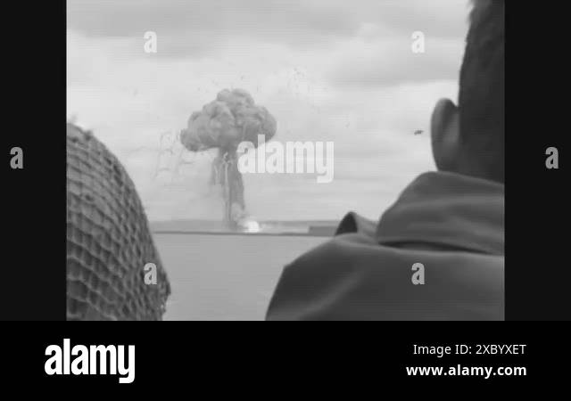 1944 - Men on a US Navy ship watch an explosion from a torpedo. Wounded ...