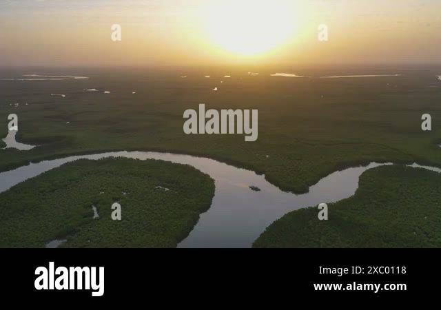 2020 - beautiful aerial over small boat moving along the Gambia river ...