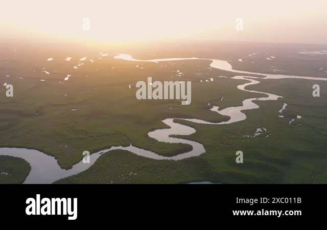 2020 - beautiful aerial over small boat moving along the Gambia river ...