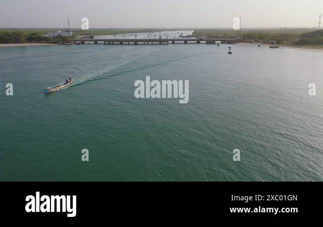 2020 - beautiful aerial over long boat moving along the Gambia river in ...