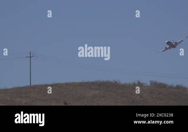 2020 - fixed wing aircraft drops fire retardant Phos chek on a brush ...
