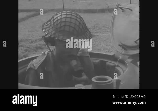 1944 - A British tank commander in the turret of a tank talks on a ...