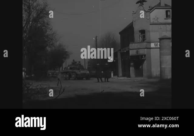 1945 - American soldiers drive tanks past Nazi POWs with their hands on ...