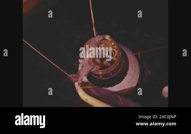 1962 - Alan Shepard inflates a raft and climbs out of an egress capsule ...