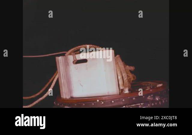 1962 - Alan Shepard climbs out of an egress capsule and inflates a raft ...