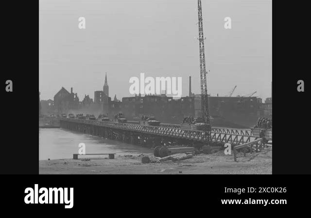 1945 - American soldiers drive DUKWS across the Gar Davidson Bridge in ...