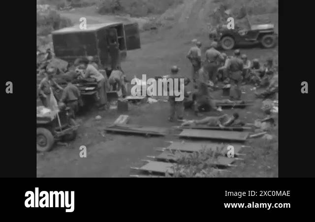 1951 - A US Army chaplain helps army doctors load wounded men onto ...