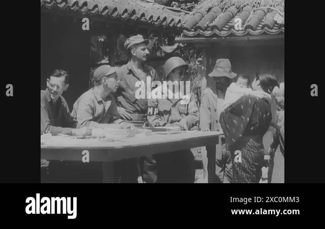 1945 - MP's process a Japanese woman and her baby at a US Military ...