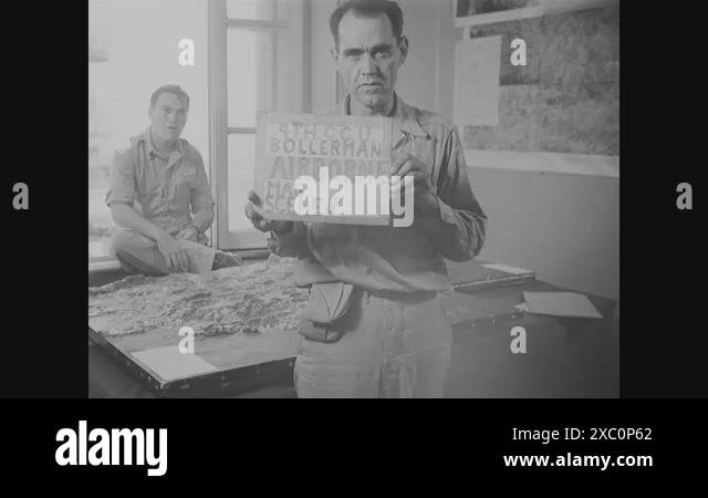1944 - Brigadier General Williams goes over a relief map with other ...