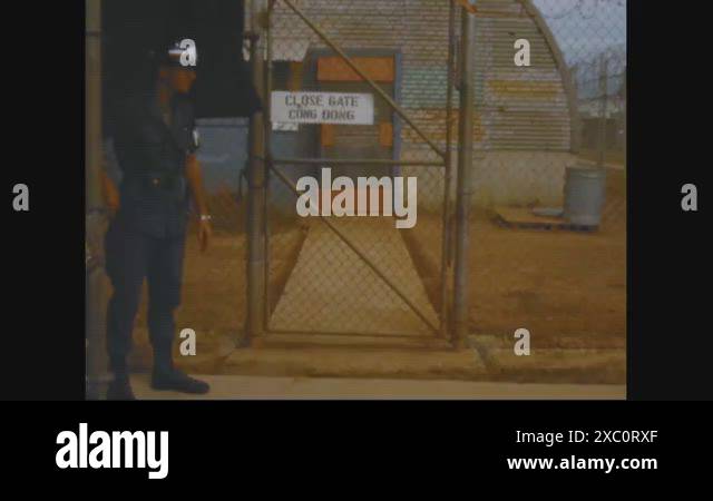 1969 - US Army MPs open gates for Vietnamese POWs carrying another ...