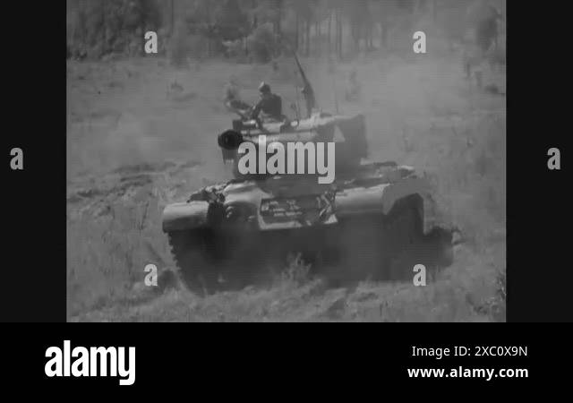 1950 - American soldiers drive M-26 tanks through a smoky field in ...
