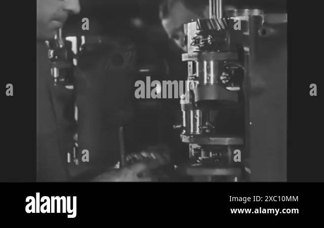 1930s - Car engines are completed on an assembly line at a Ford ...