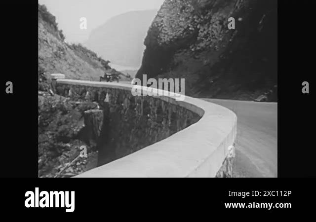 1910s - Ford cars drive around steep curves, over bridges and through ...