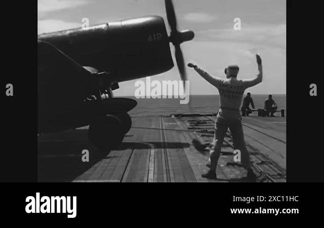 1950 - The flight deck officer on the USS Valley Forge directs F4U and ...