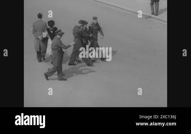 1940s - Men and women of the British Army walk down a boardwalk ...