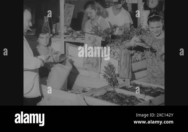 1937 - People patronize a fish market and enclosed grocery market on ...