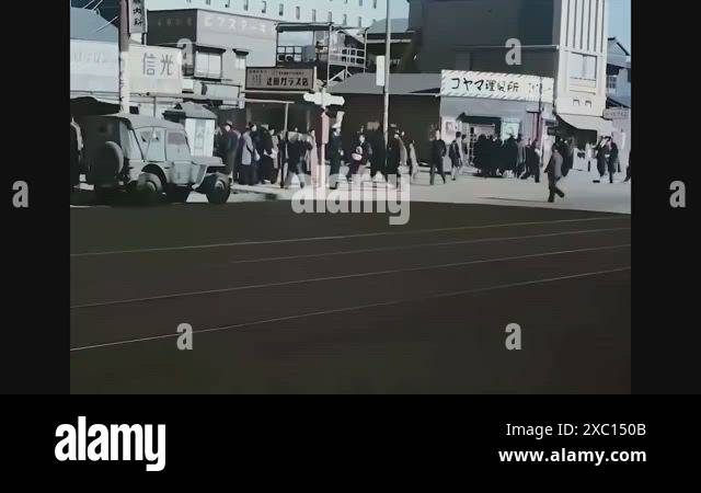 1940s - Pedestrian and vehicular traffic in a Japanese city includes ...